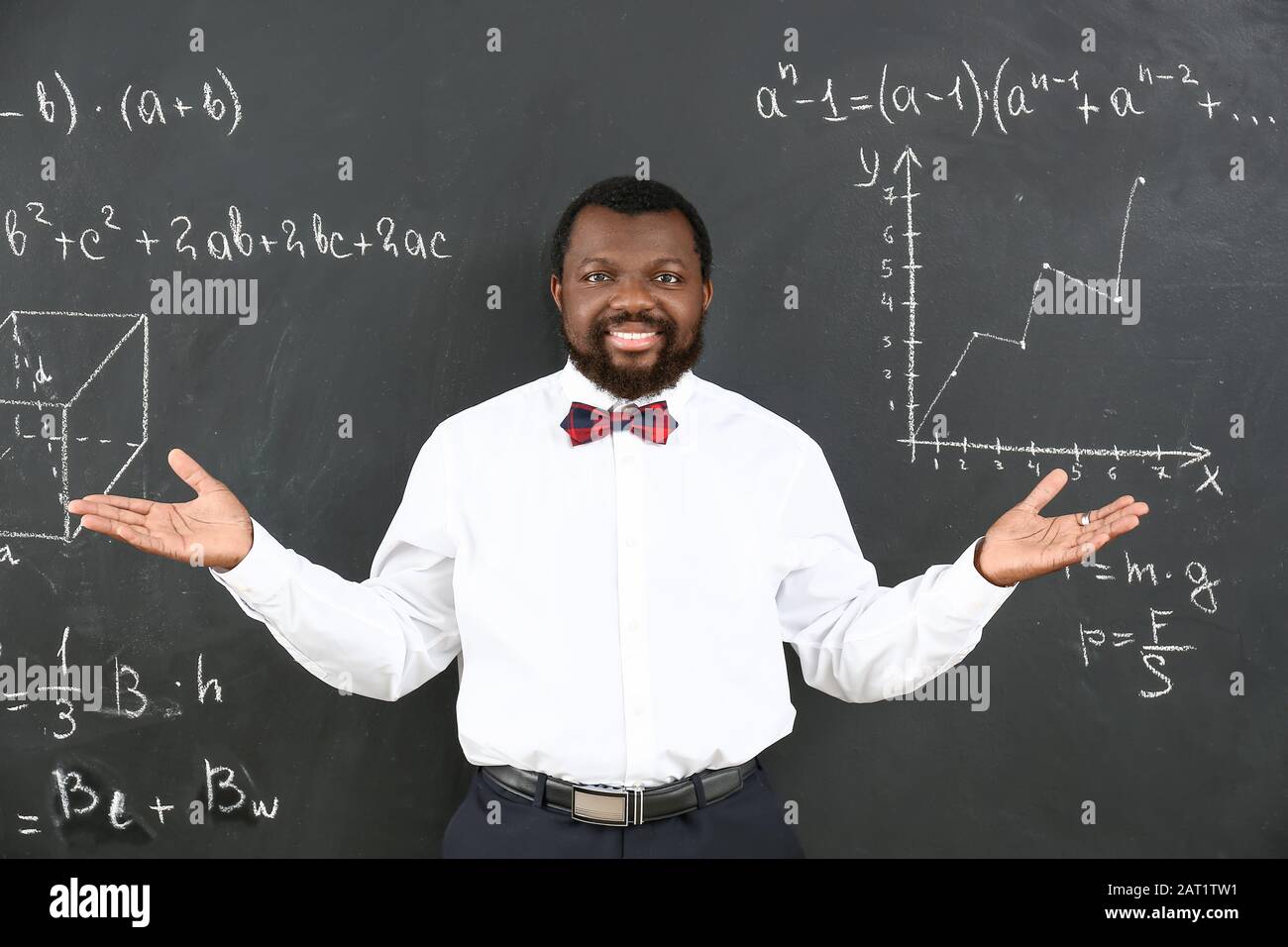 African-American math teacher near blackboard in classroom Stock Photo ...