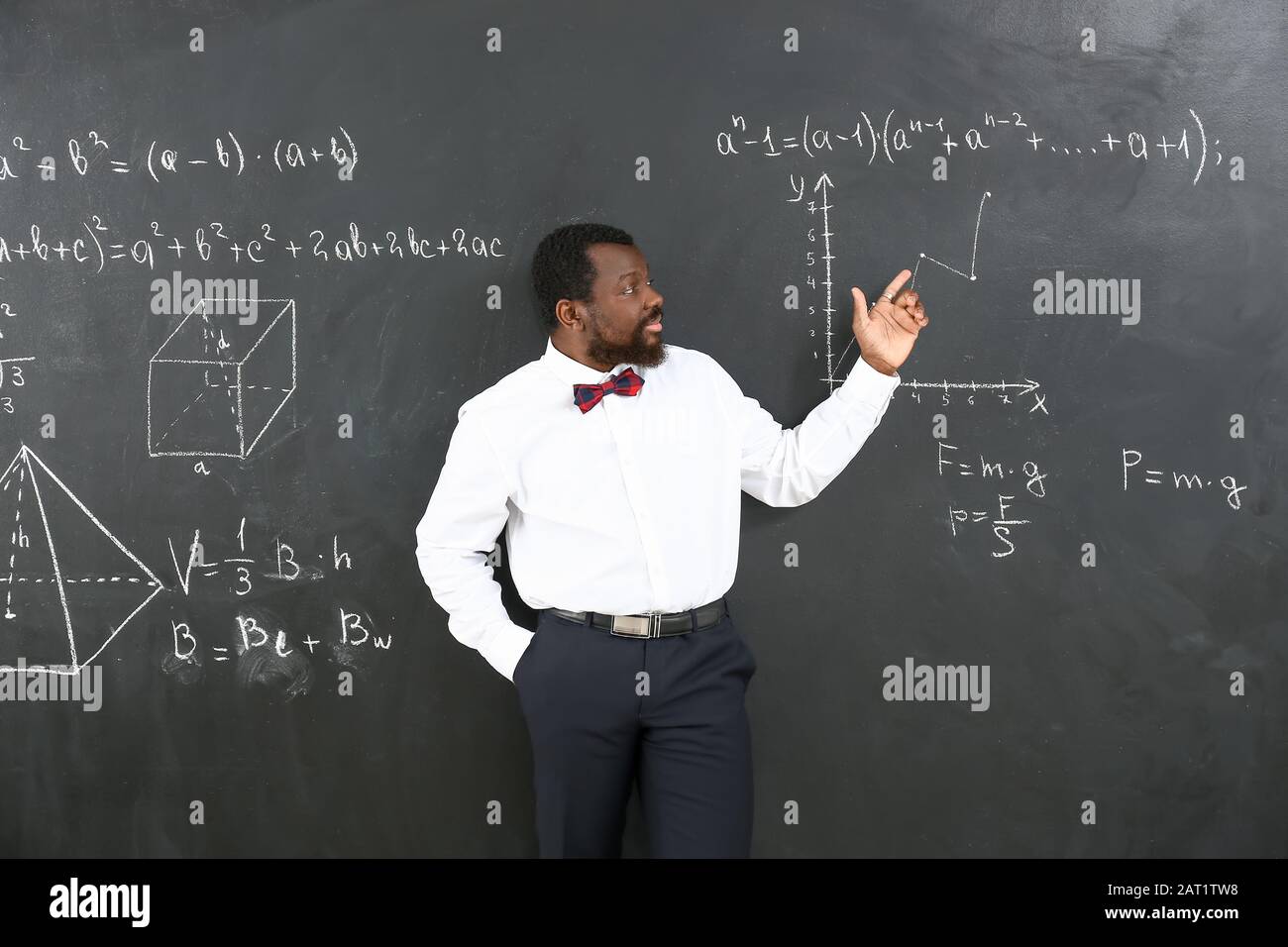 African-American math teacher near blackboard in classroom Stock Photo ...