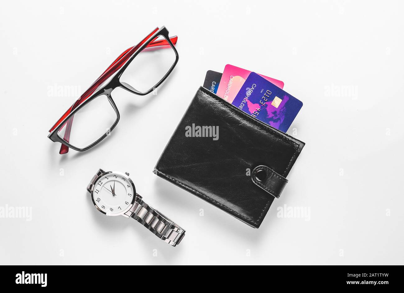 Wallet with credit cards, clock and eyeglasses on white background ...