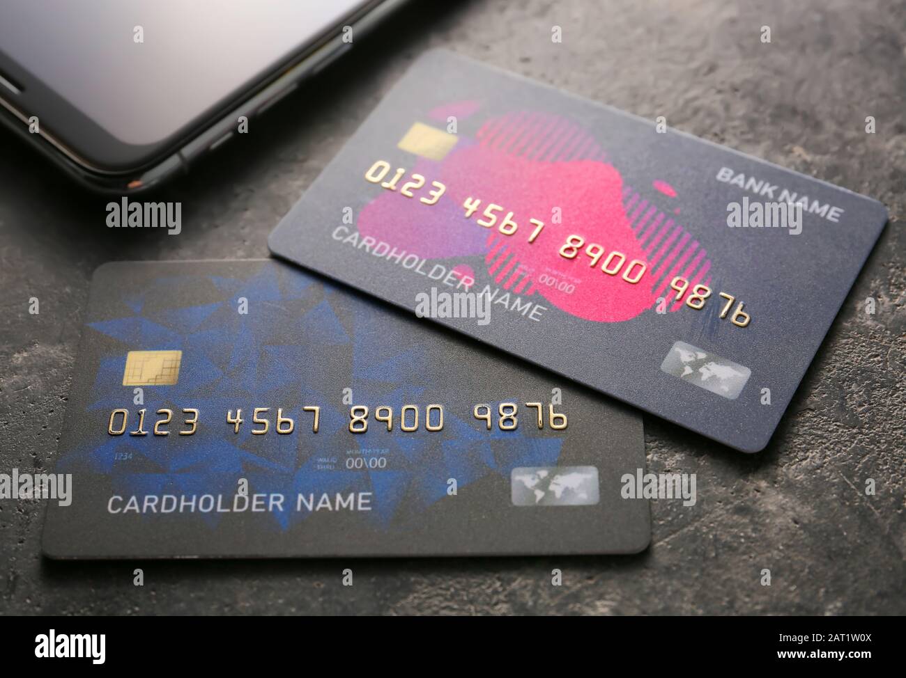 Different credit cards with mobile phone on dark background Stock Photo ...