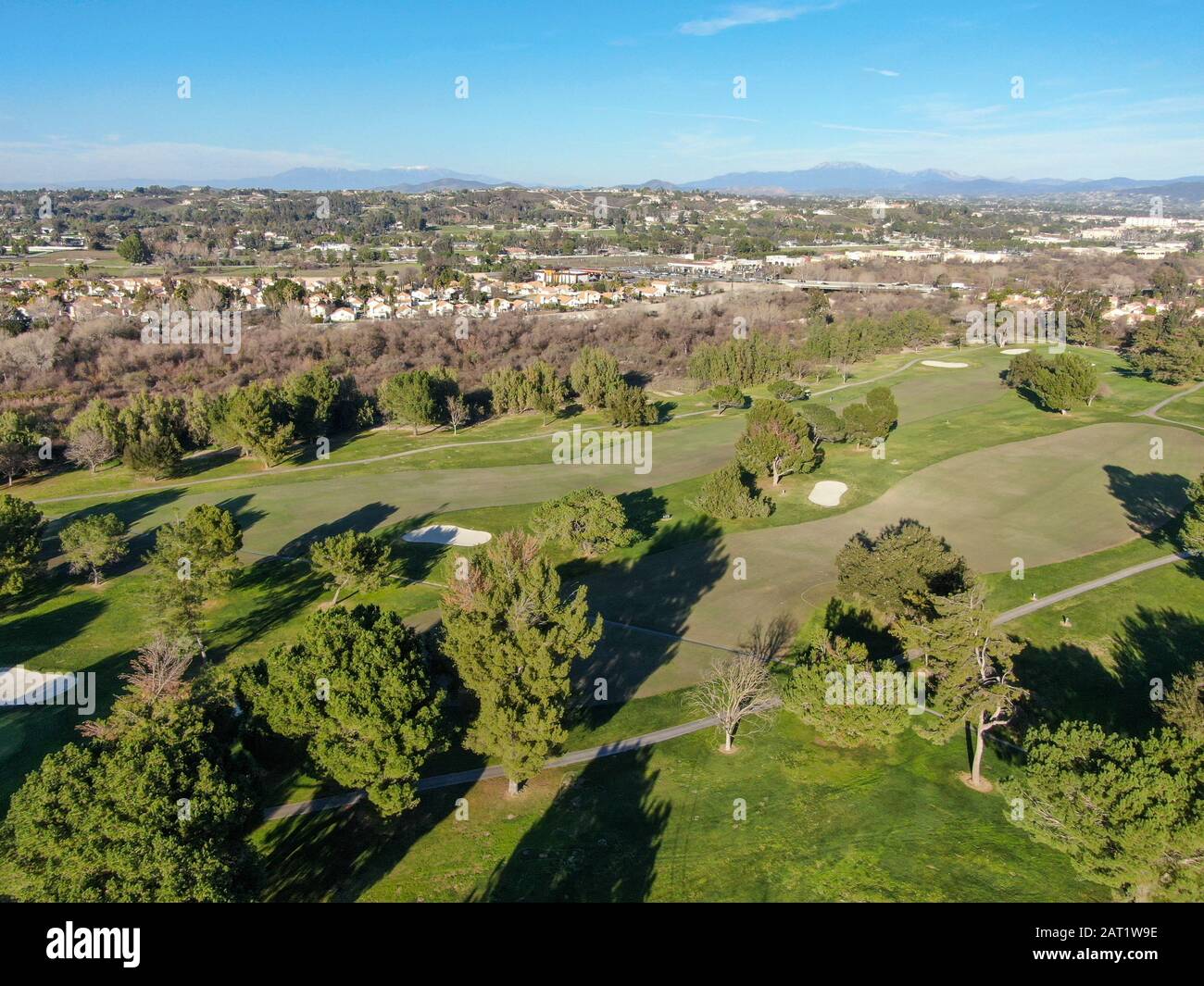 Aerial view of golf course with green field in the valley. Green turf ...