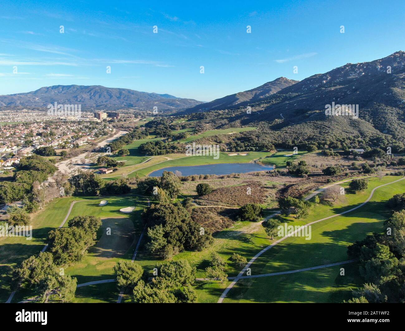 Aerial view of golf course with green field in the valley. Green turf ...