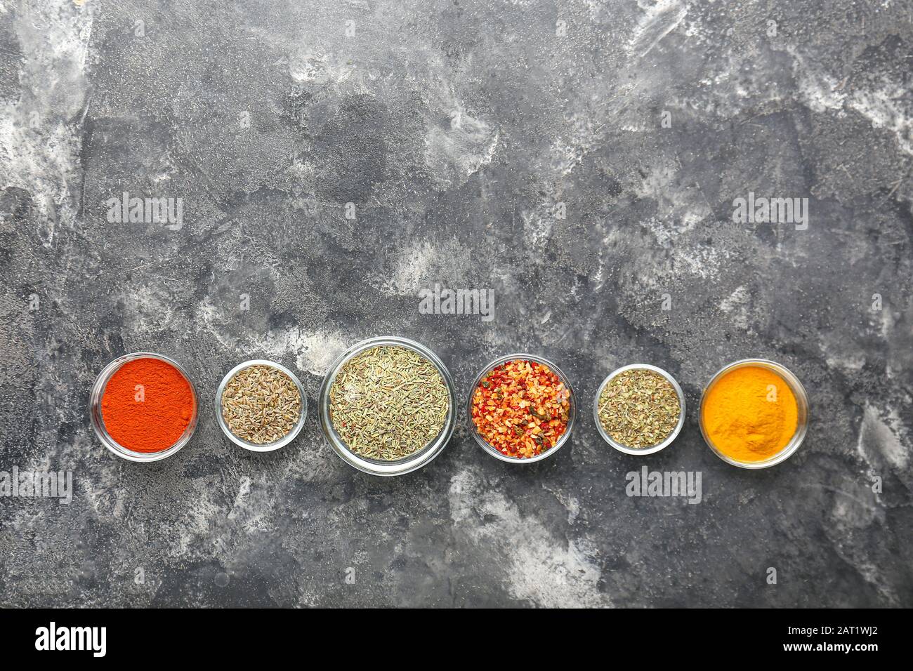 Many different spices on grey background Stock Photo - Alamy