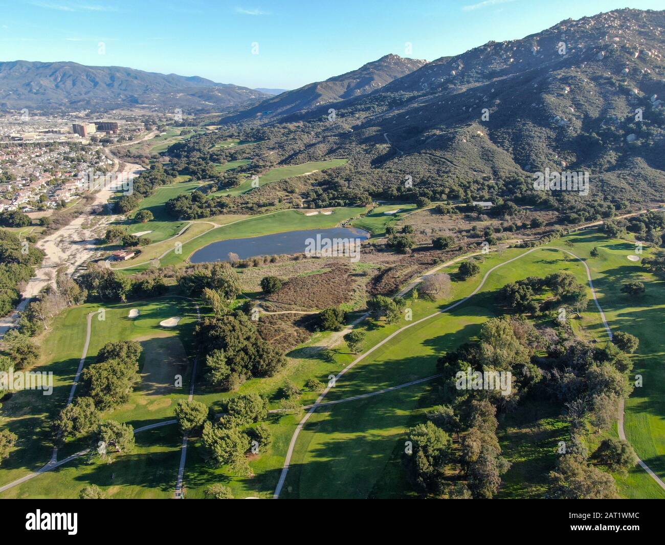 Aerial view of golf course with green field in the valley. Green turf ...