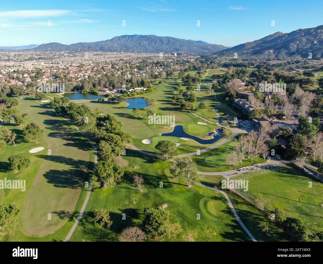 Aerial view of golf course with green field in the valley. Green turf ...