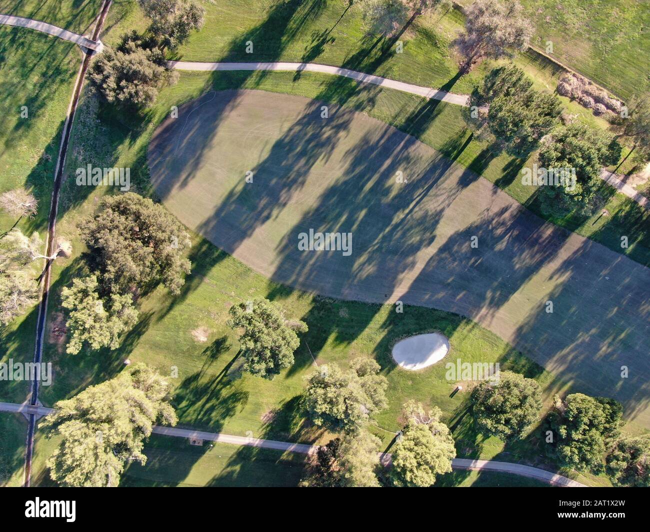 Aerial view of golf course with green field in the valley. Green turf ...