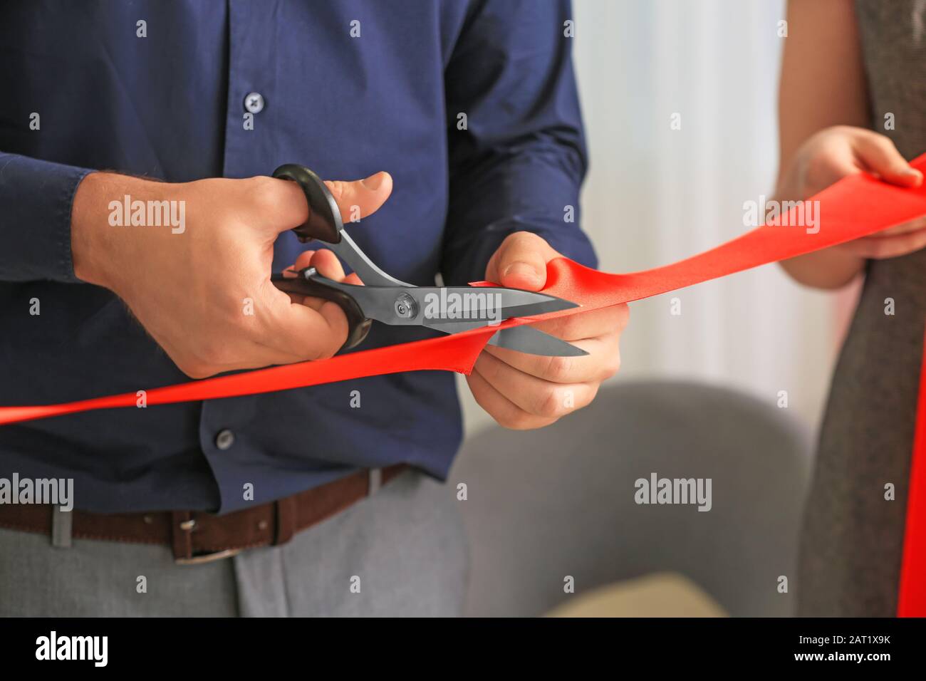 Man cutting red ribbon at the opening ceremony Stock Photo - Alamy
