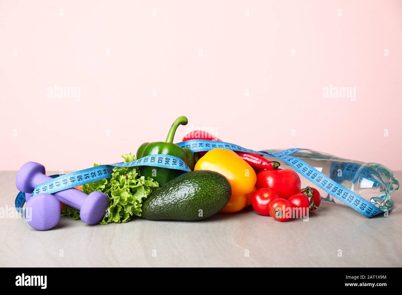 Different healthy food with measuring tape and dumbbells on table. Diet ...