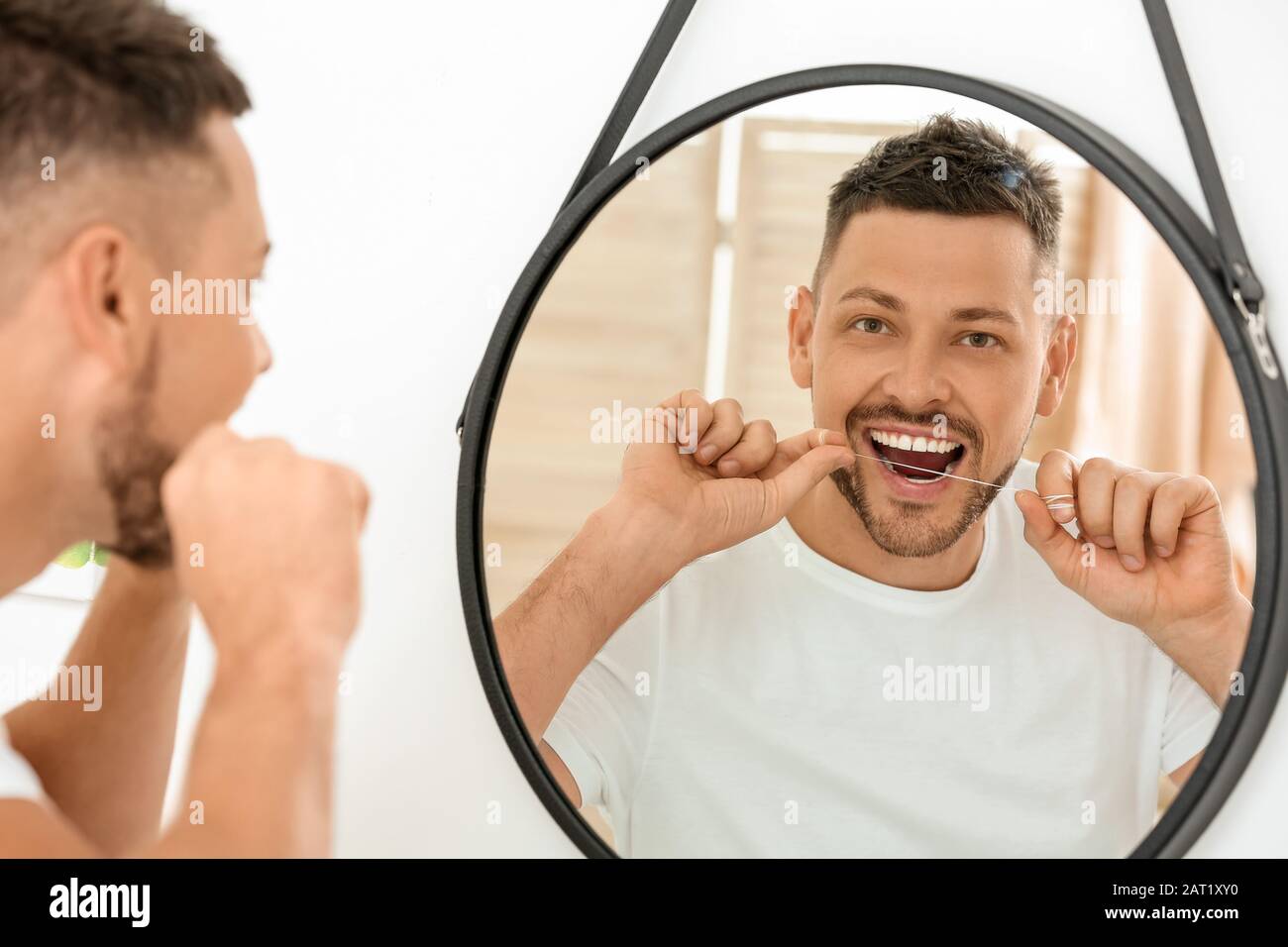 Man flossing teeth hi-res stock photography and images - Alamy