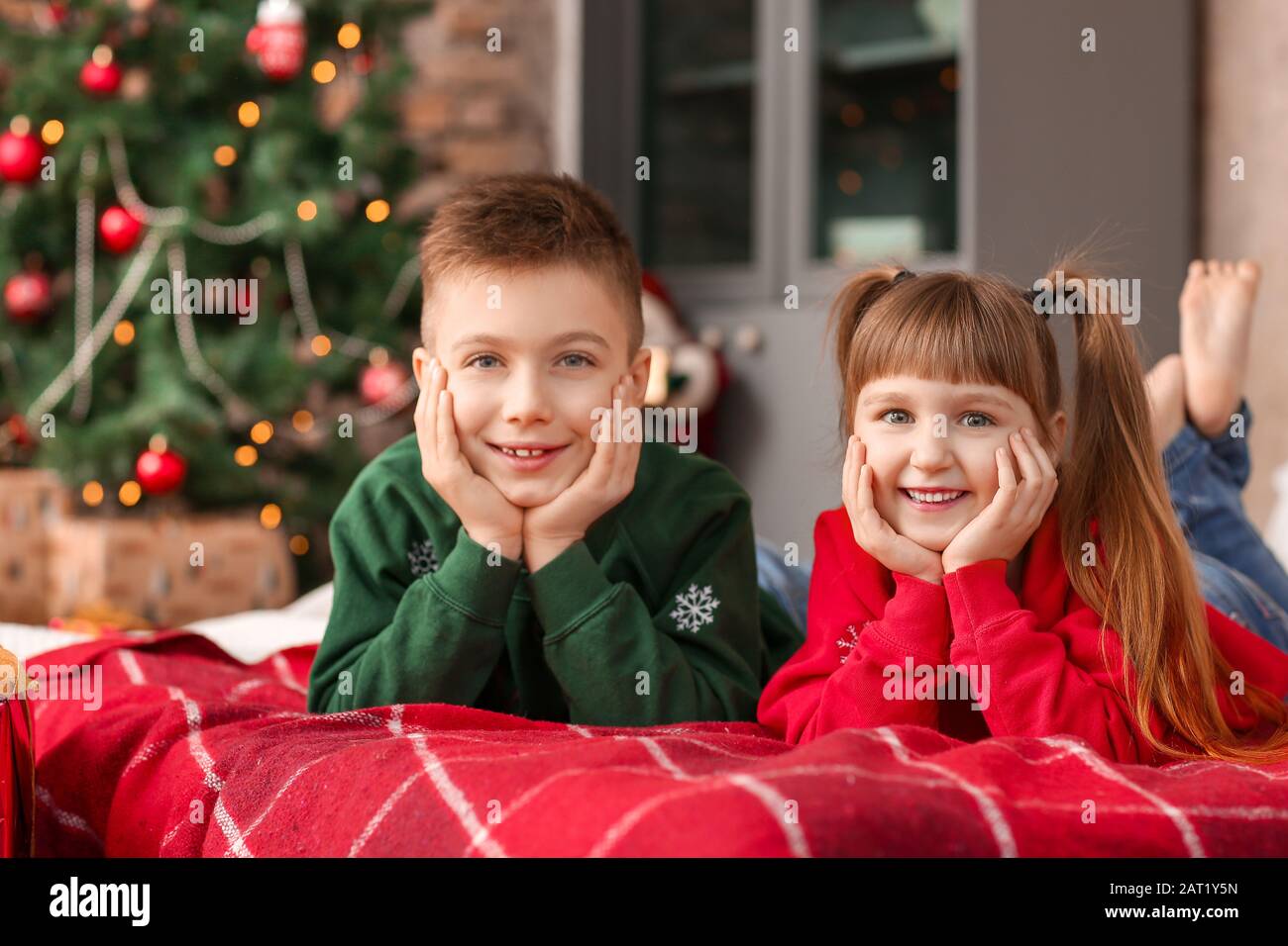 Little children resting on bed at home Stock Photo - Alamy