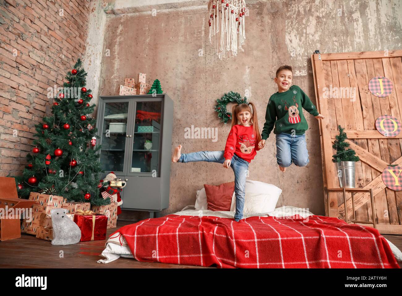 Happy children jumping on Christmas eve at home Stock Photo - Alamy
