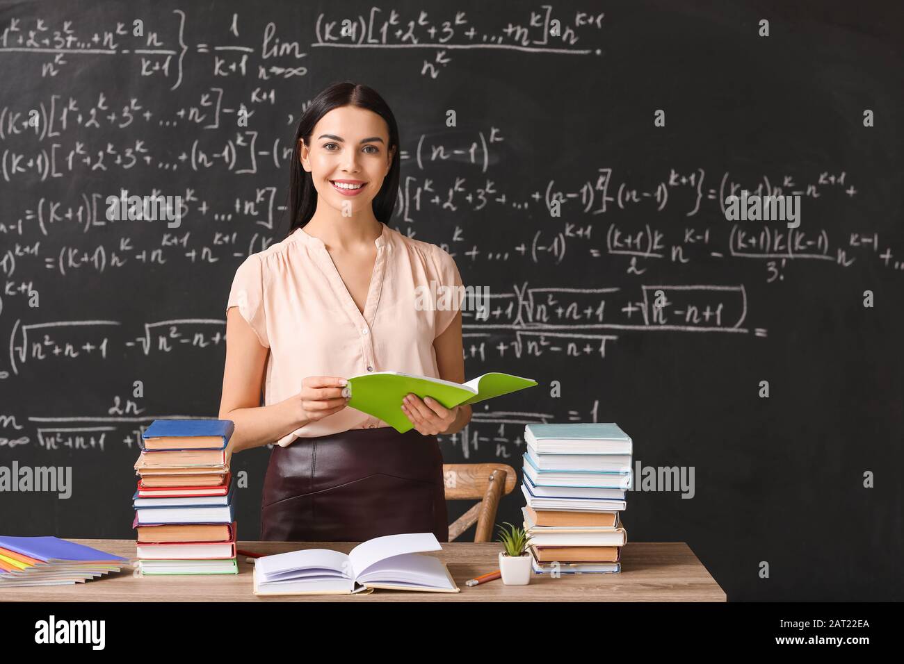 Female teacher at workplace in classroom Stock Photo - Alamy