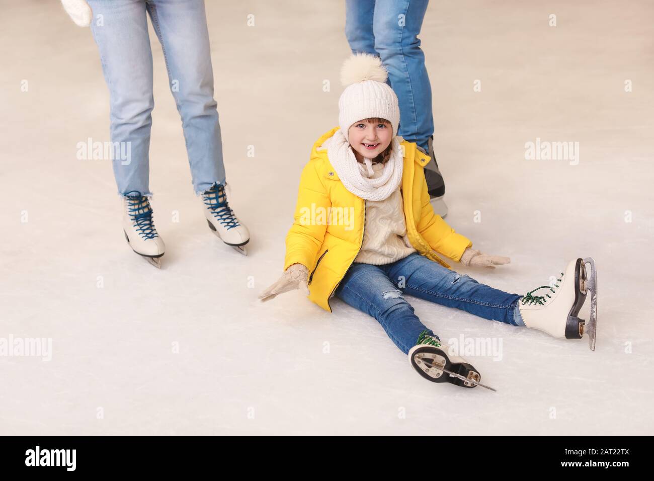 Cute little girl after falling on skating rink Stock Photo - Alamy