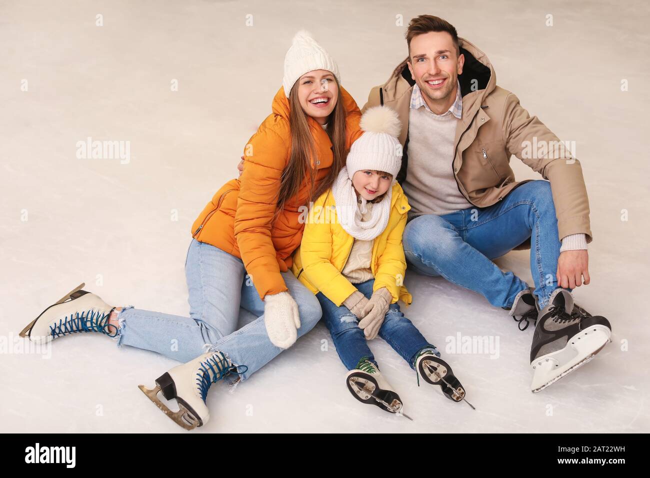 Happy family on skating rink Stock Photo - Alamy