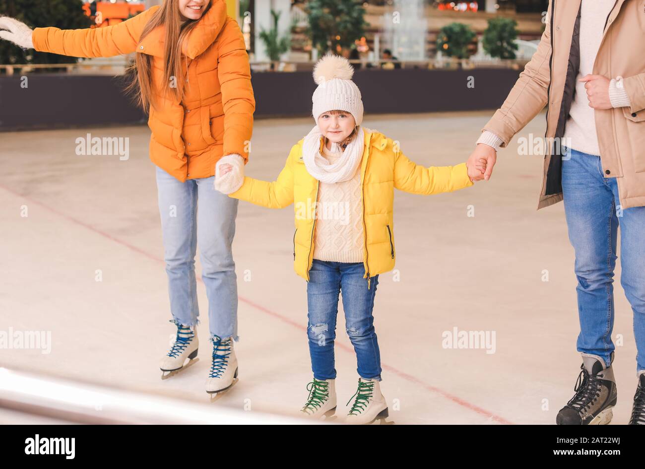 Happy family on skating rink Stock Photo - Alamy