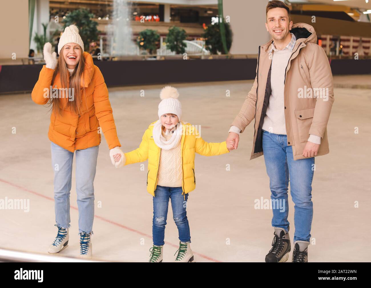 Happy family on skating rink Stock Photo - Alamy