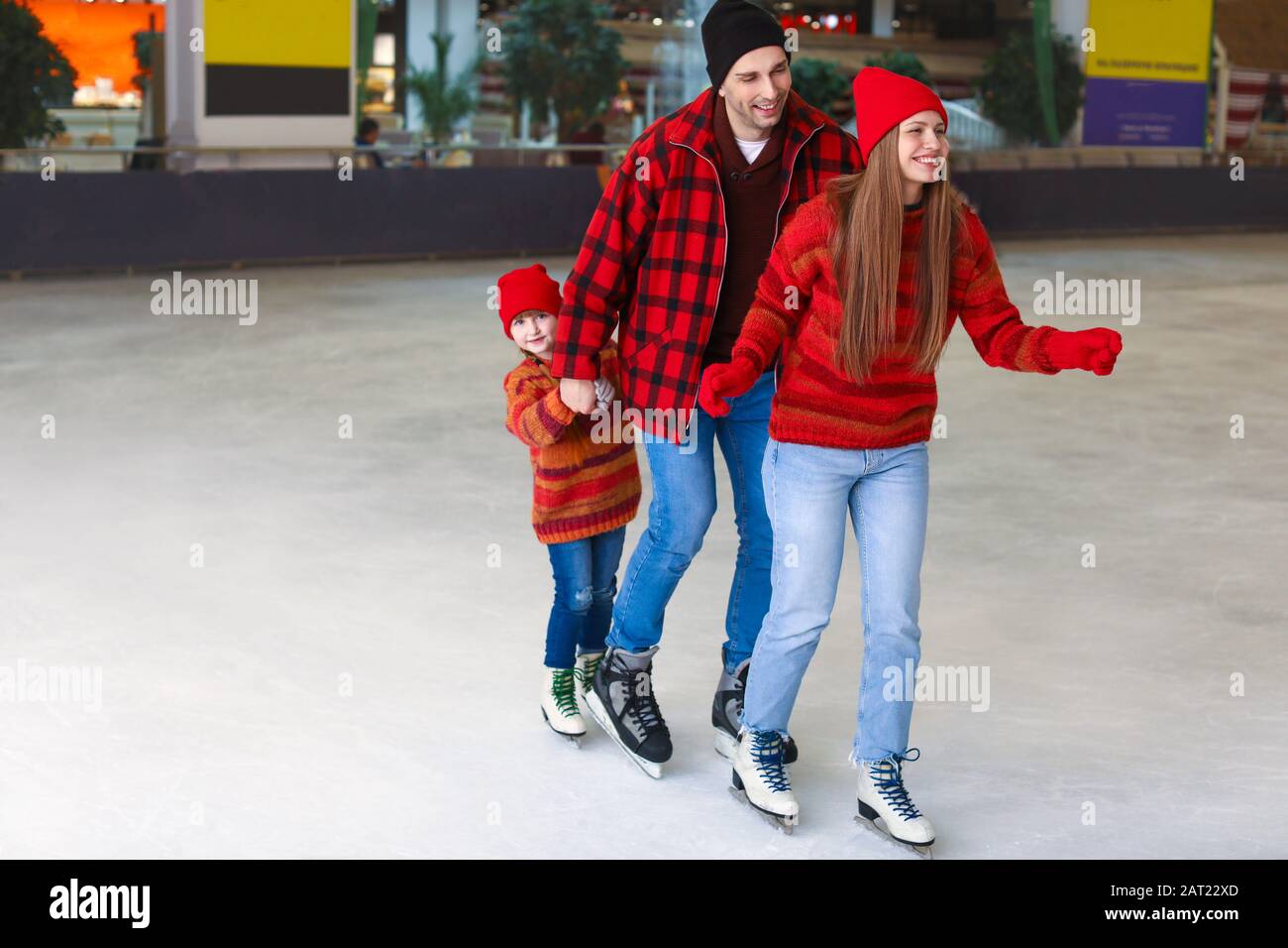 Happy family on skating rink Stock Photo - Alamy