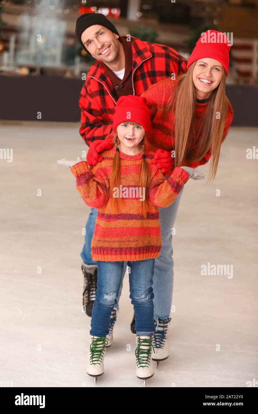 Happy family on skating rink Stock Photo - Alamy