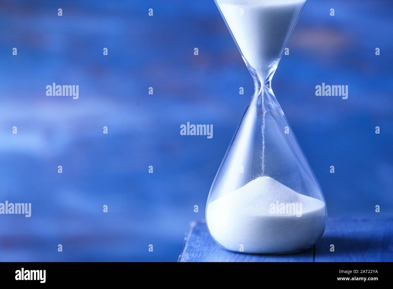 Hourglass on color background. Time management concept Stock Photo - Alamy