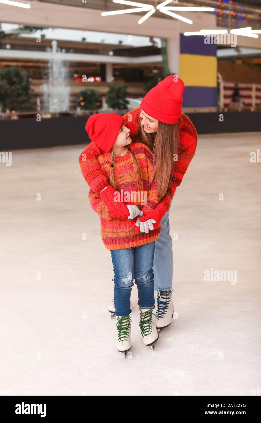 Young mother with little daughter on skating rink Stock Photo - Alamy