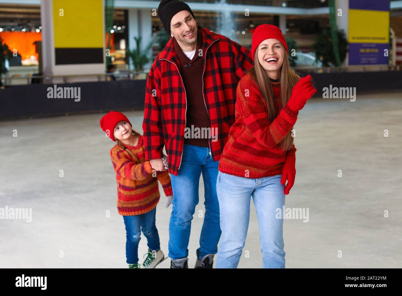 Happy family on skating rink Stock Photo - Alamy
