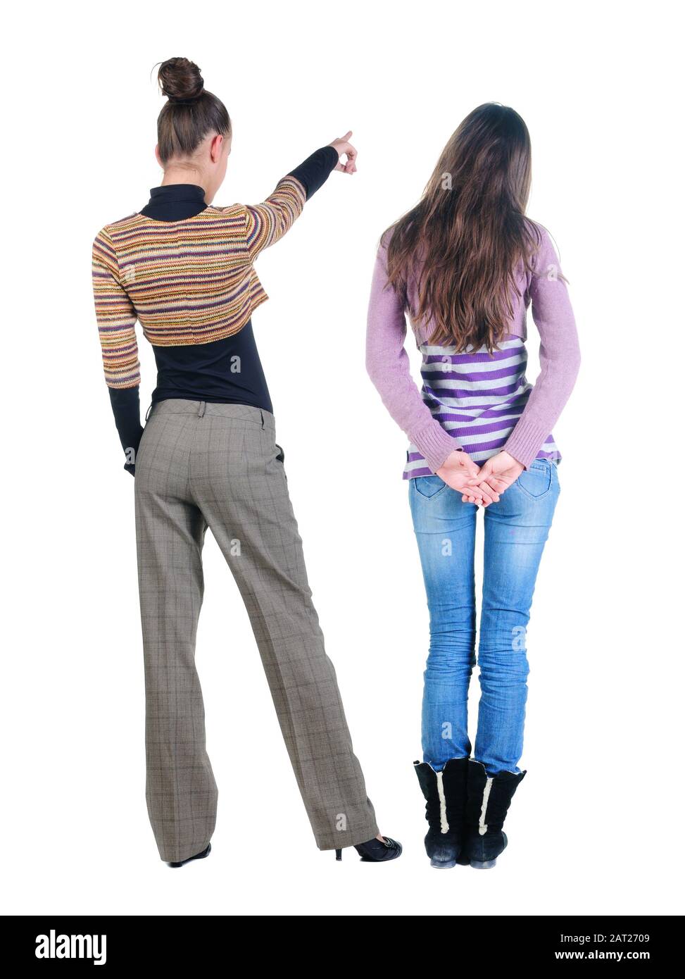 Back view of two pointing young girl in sweater. Rear view people ...