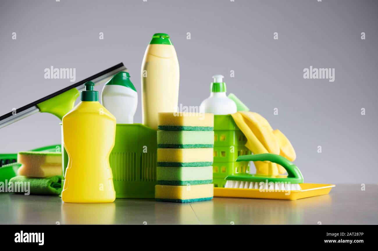 Spring house cleaning theme. Colorful cleaning products on white table ...