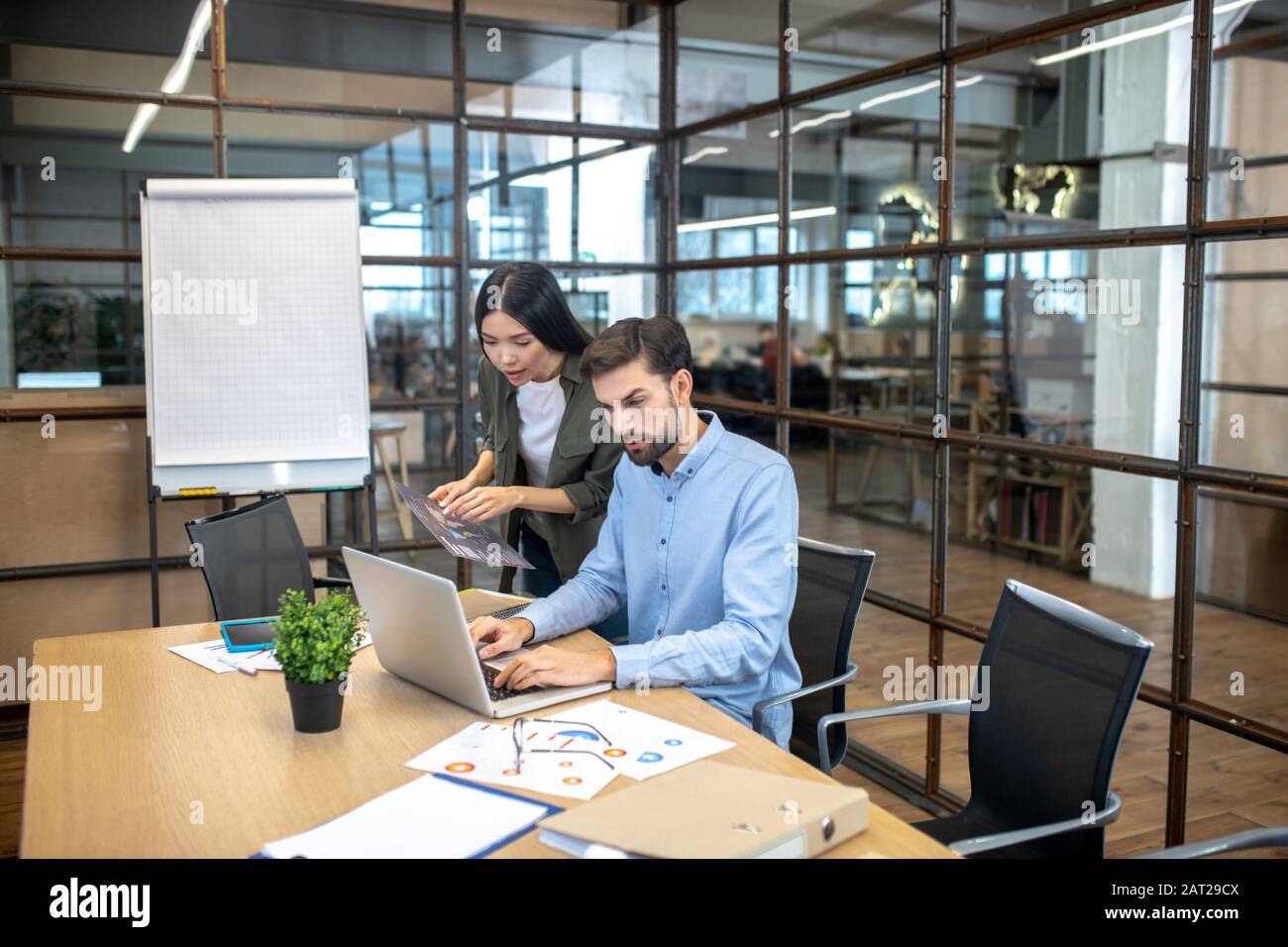 Two colleagues working together and looking busy Stock Photo - Alamy