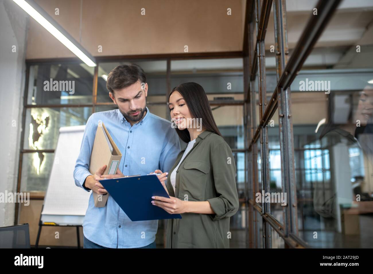 Two colleagues working on the project together Stock Photo - Alamy
