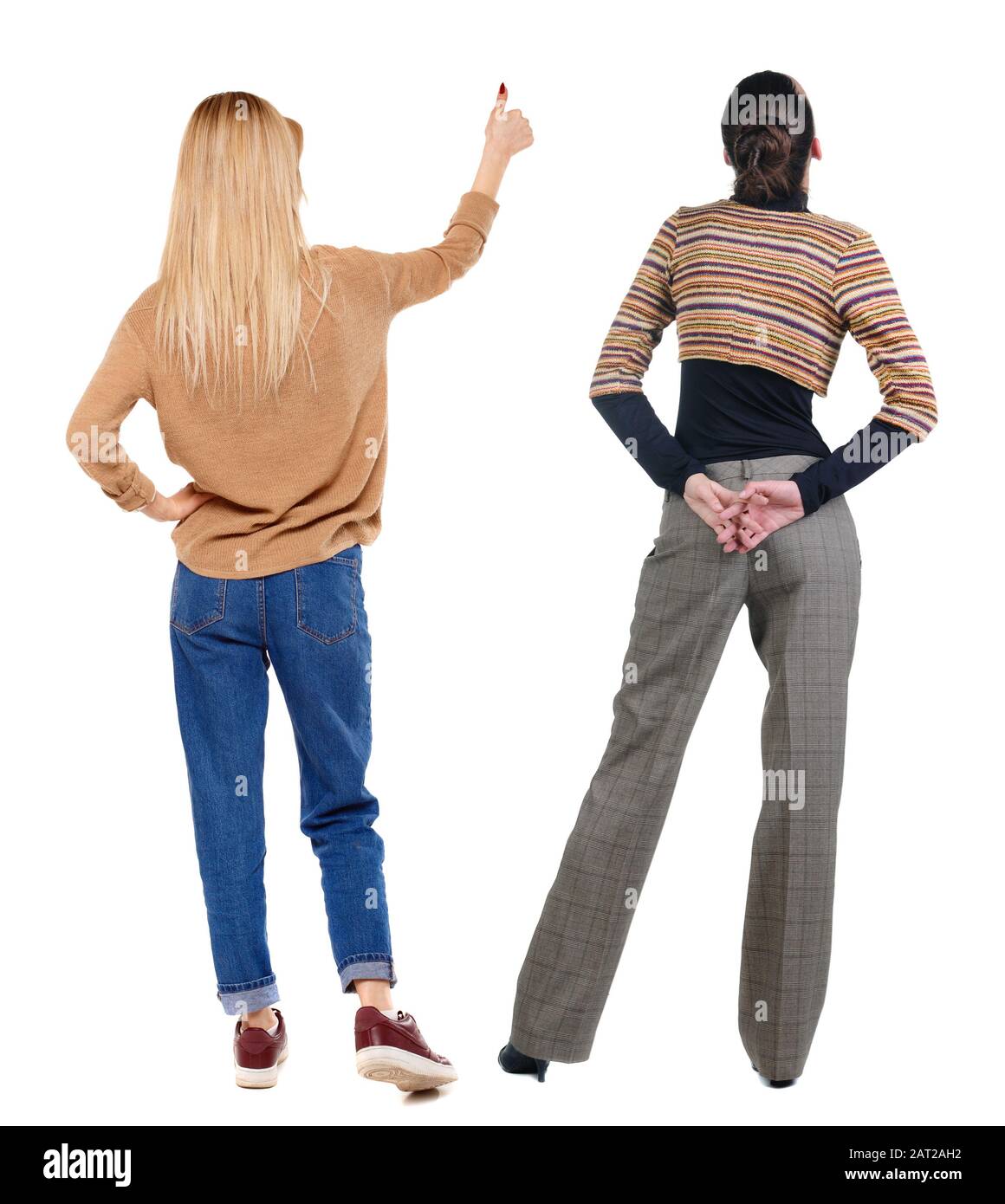 Back view of two young girl in sweater showing thumb up. Rear view ...