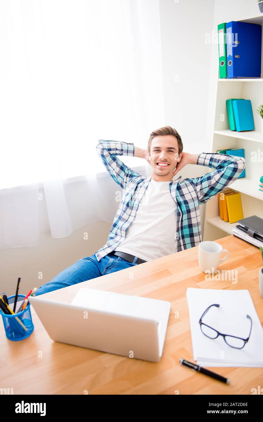 Cheerful young man relaxing after completing hard task Stock Photo - Alamy