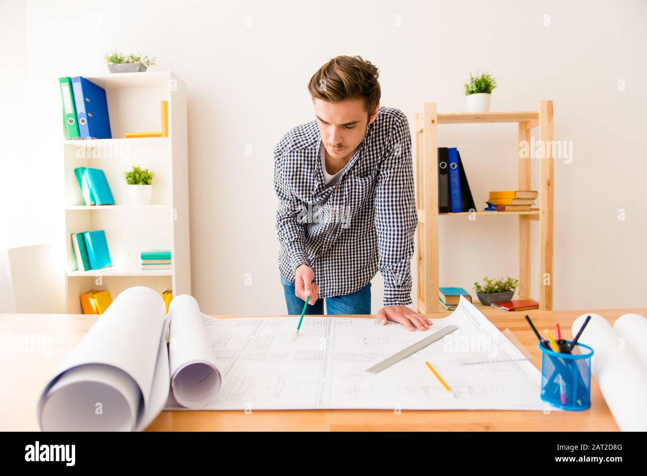 Smart young engineer drawing scheme for his project Stock Photo - Alamy