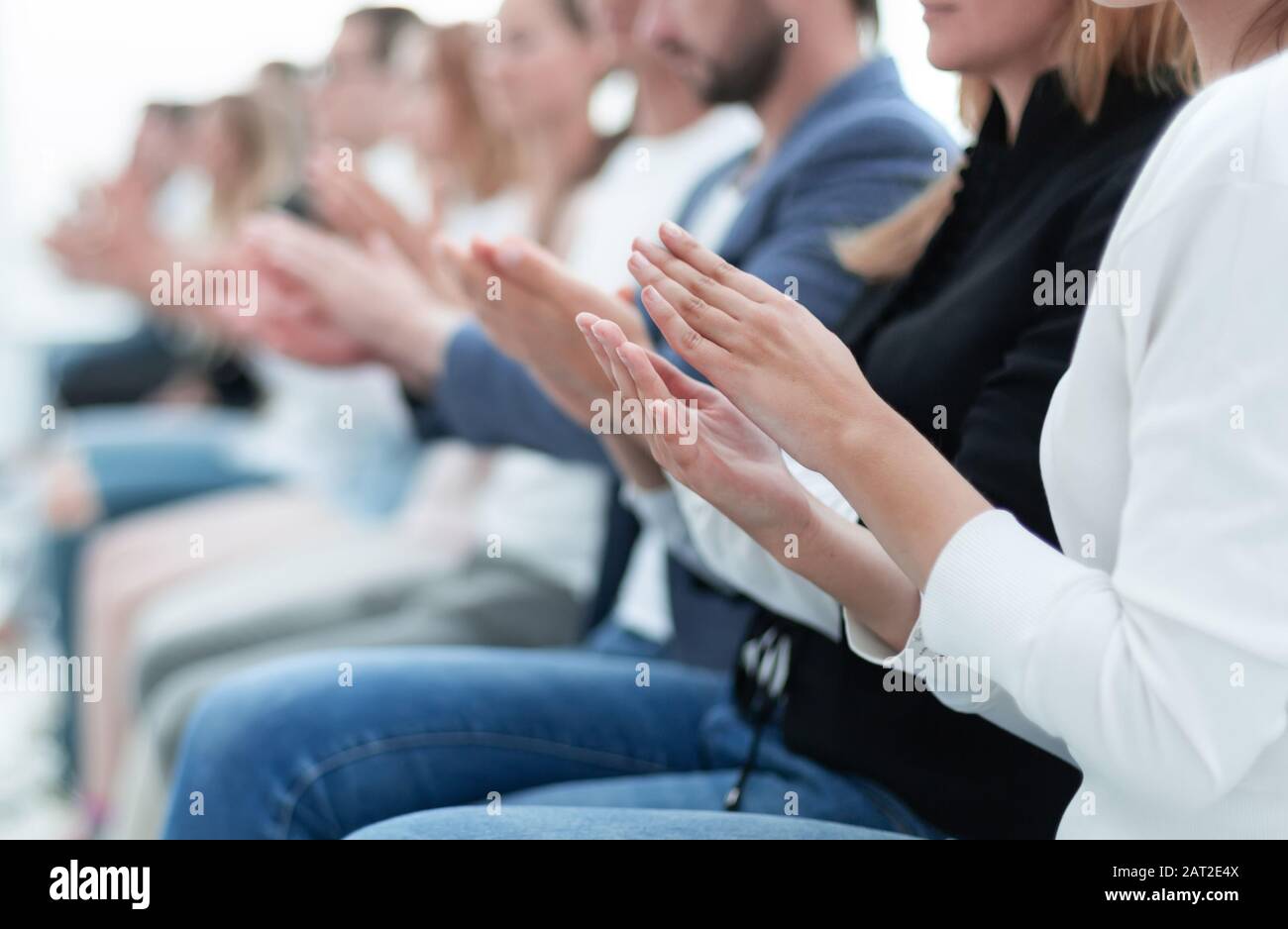 group of young people applauding sitting in the conference room Stock ...