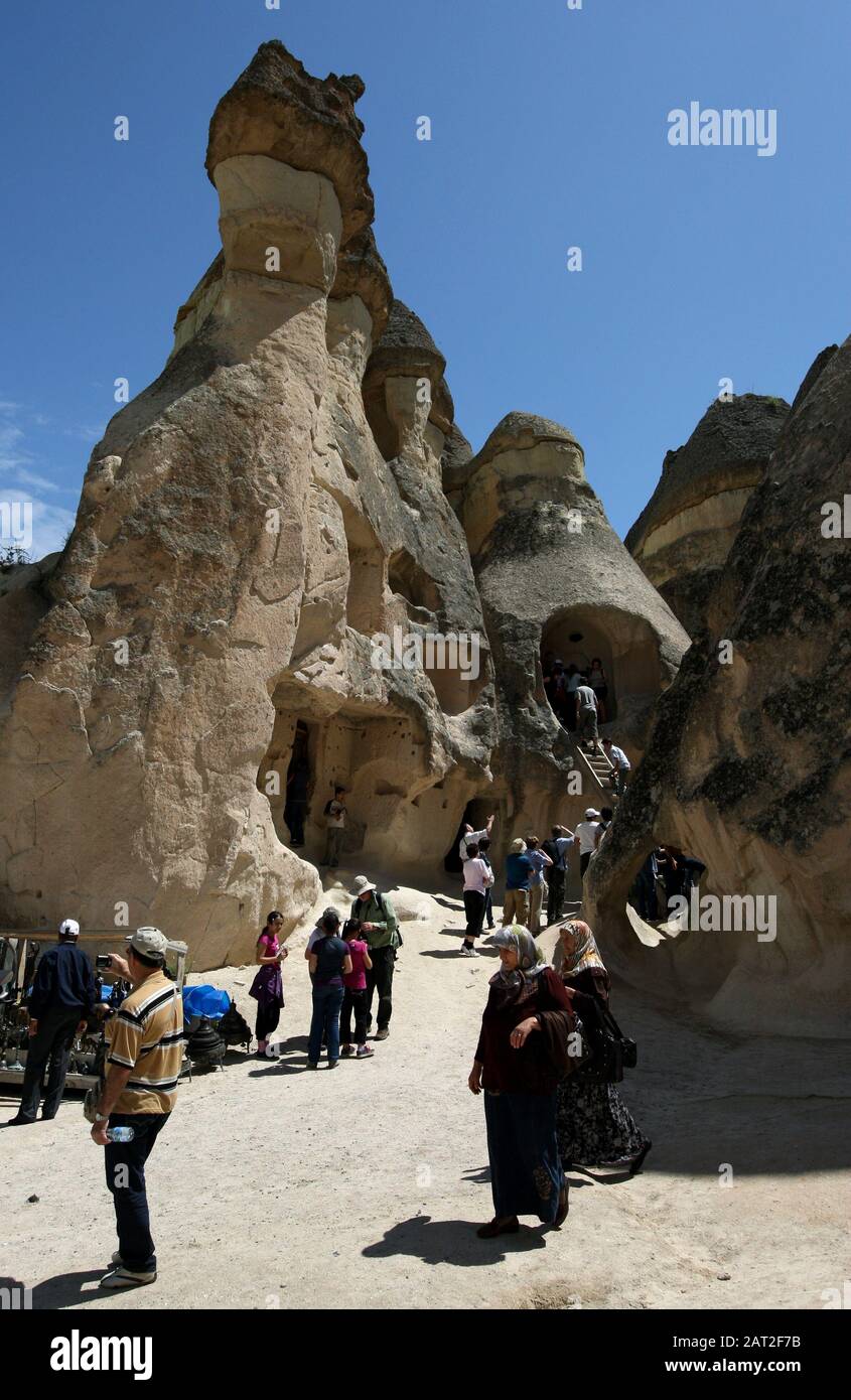 Tourists gather around a unique series of volcanic rock formations ...