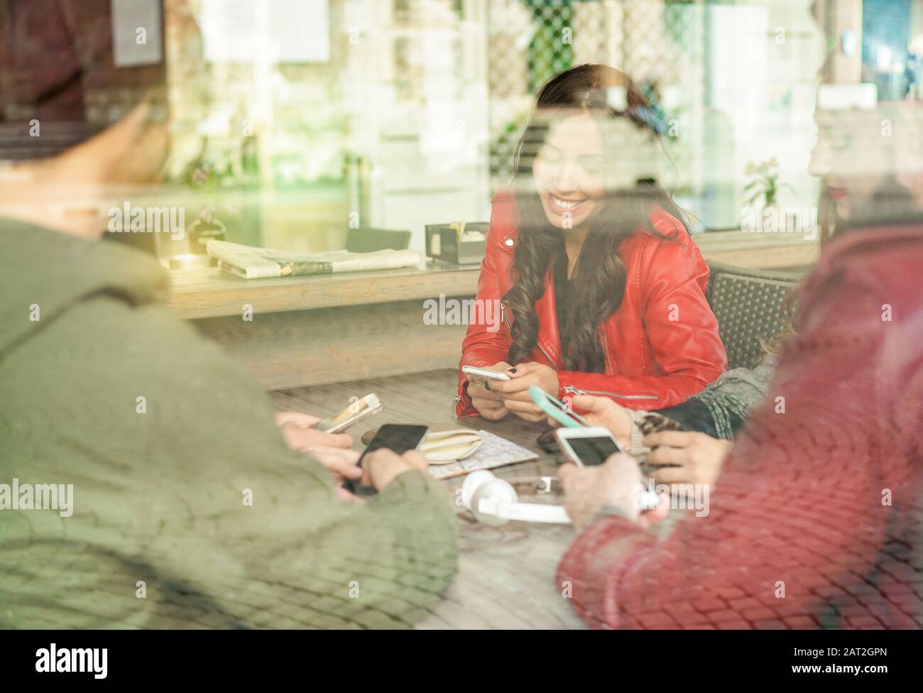 Happy friends waiting for coffee sitting in bar - Window reflection ...