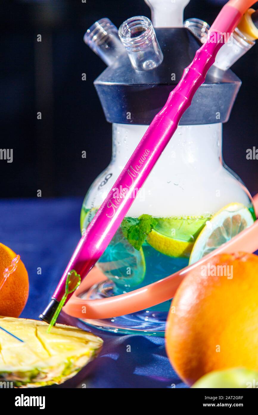 The hookah flask is round and transparent, filled with blue-green ...