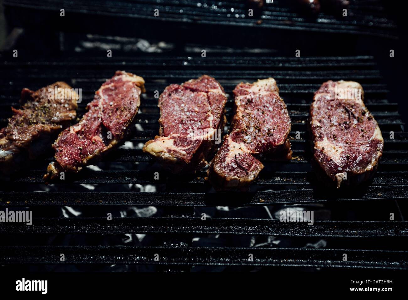 Preparetion of red meat on the grill Stock Photo - Alamy