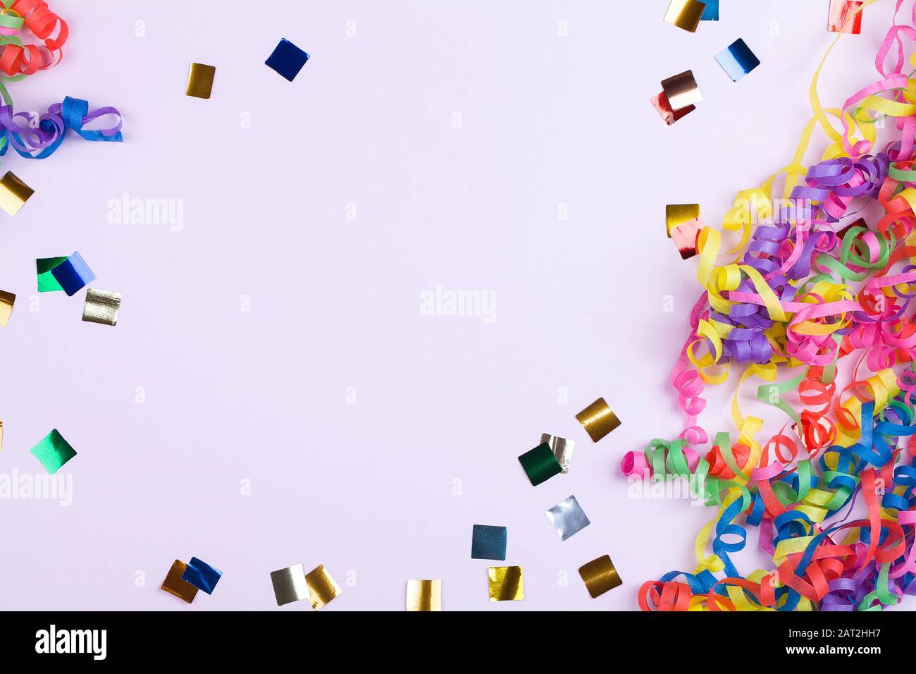 Festive party border or frame of colorful spiral streamers and confetti ...