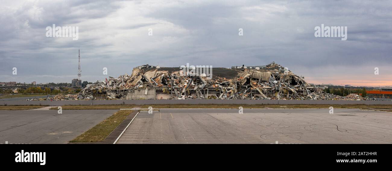 Crumbled concrete building with piles of debris. panoramic photo shot ...