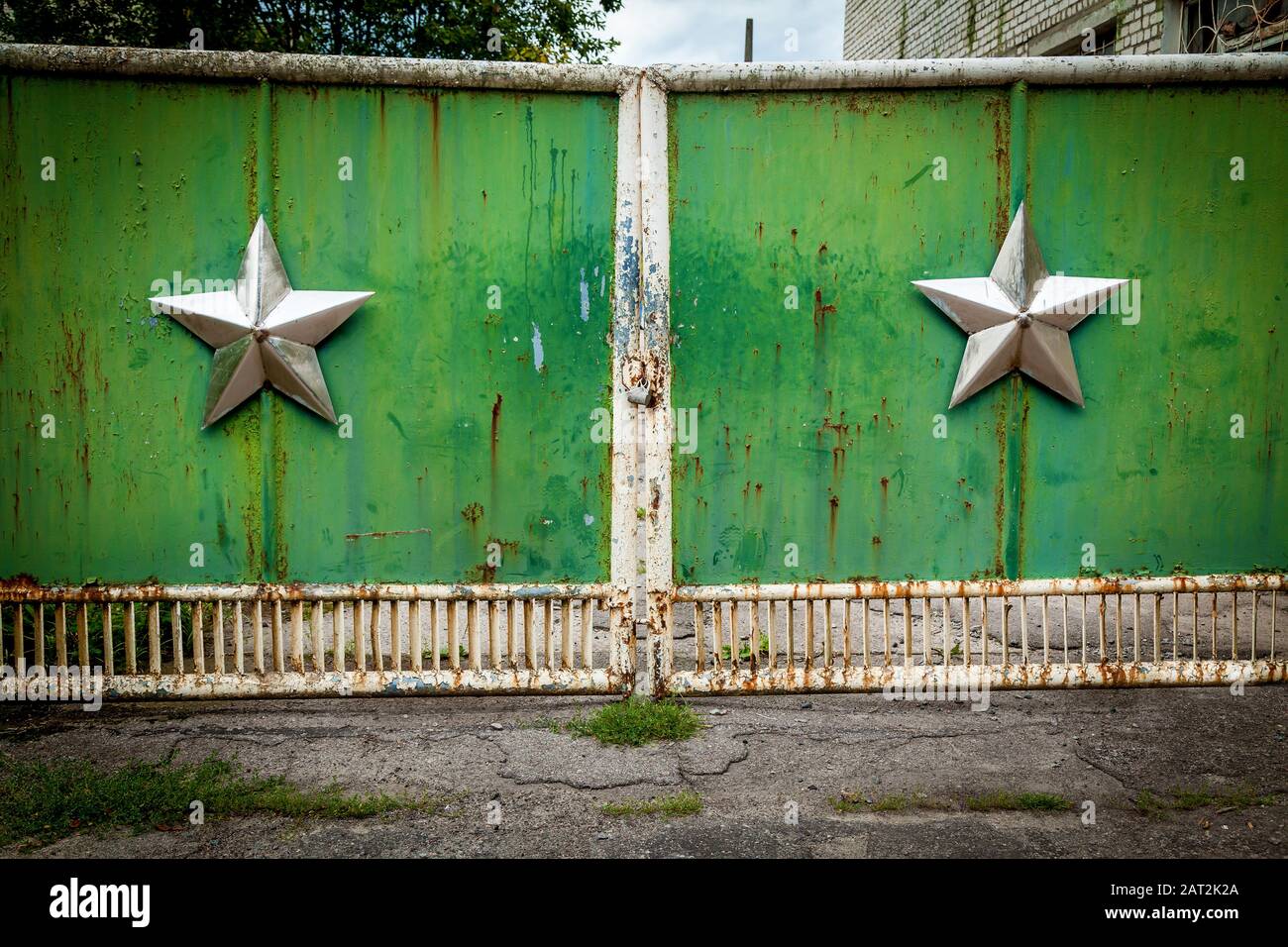 Old abandoned gate with a metal star of a military unit in Pripyat ...