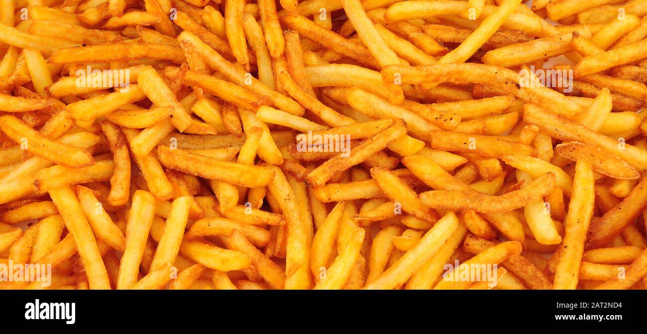 Crispy golden French fries background Stock Photo - Alamy