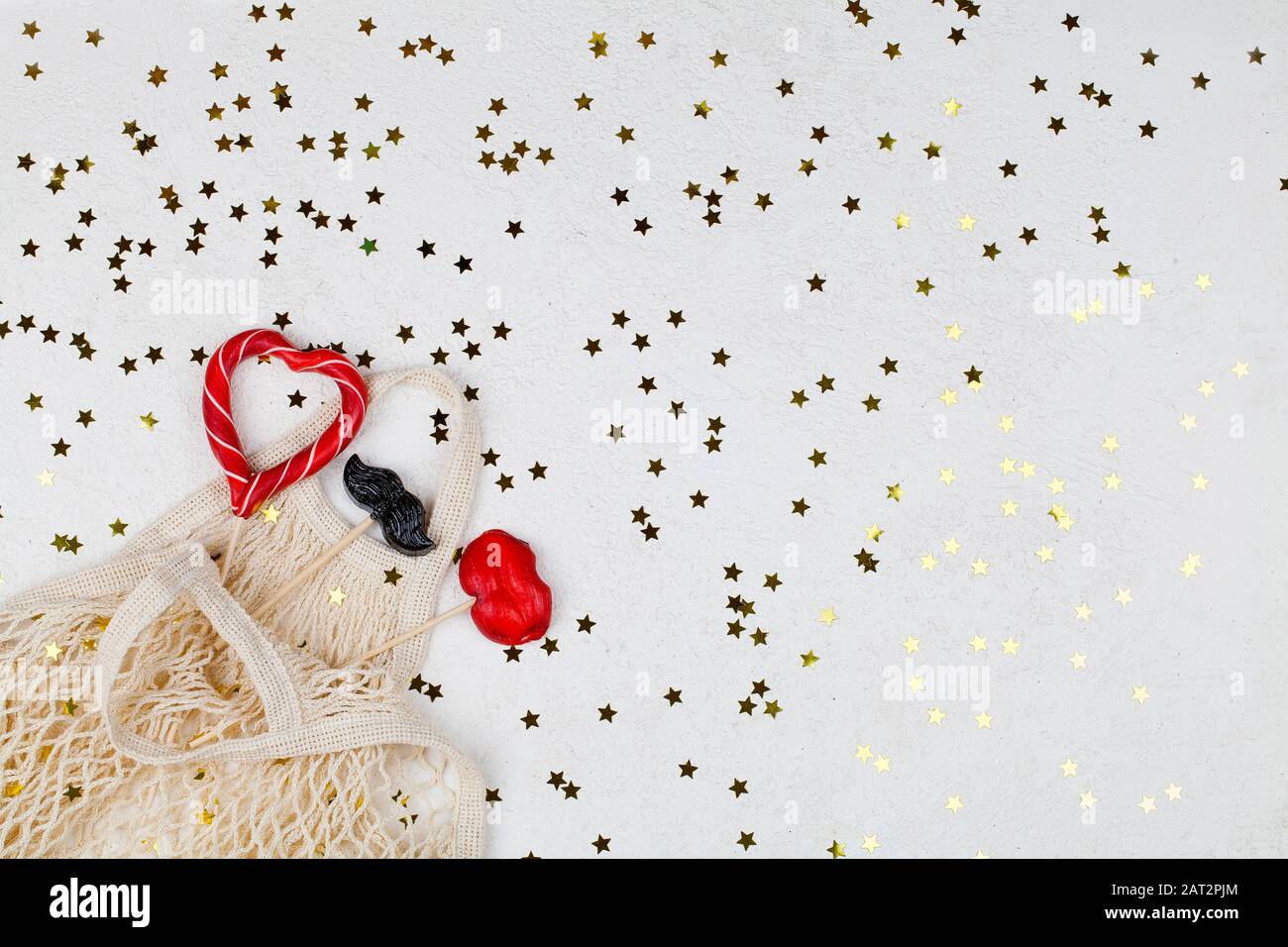 red and black lollipop in shape of heart, lip and mustache in mesh bag ...