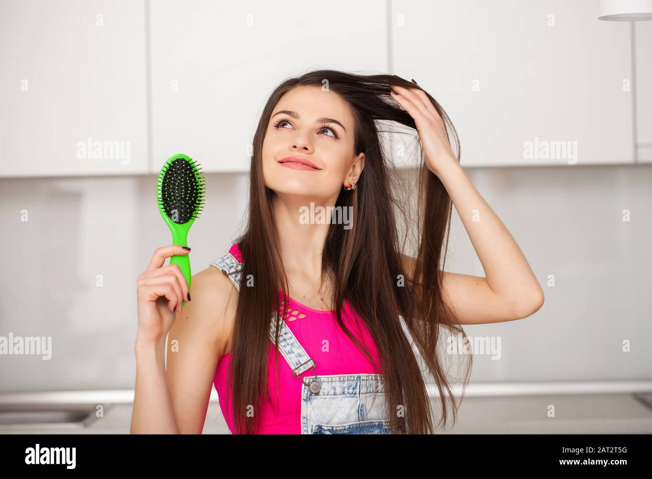 Girl holds a hairbrush without hair and smiling Stock Photo - Alamy