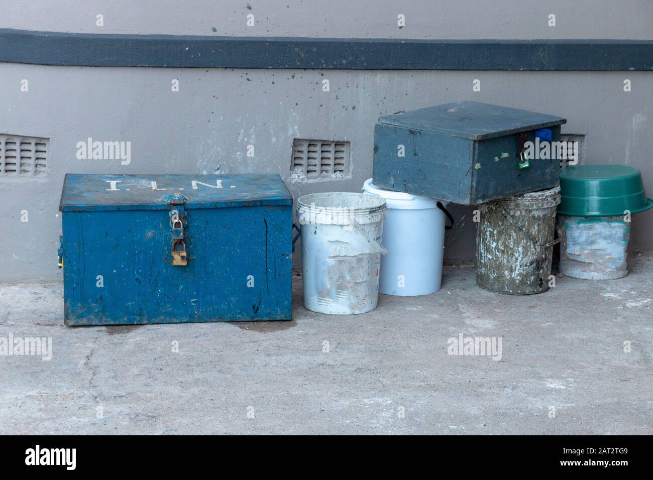 a close up view of a old blue workers box that has locks to keep it ...
