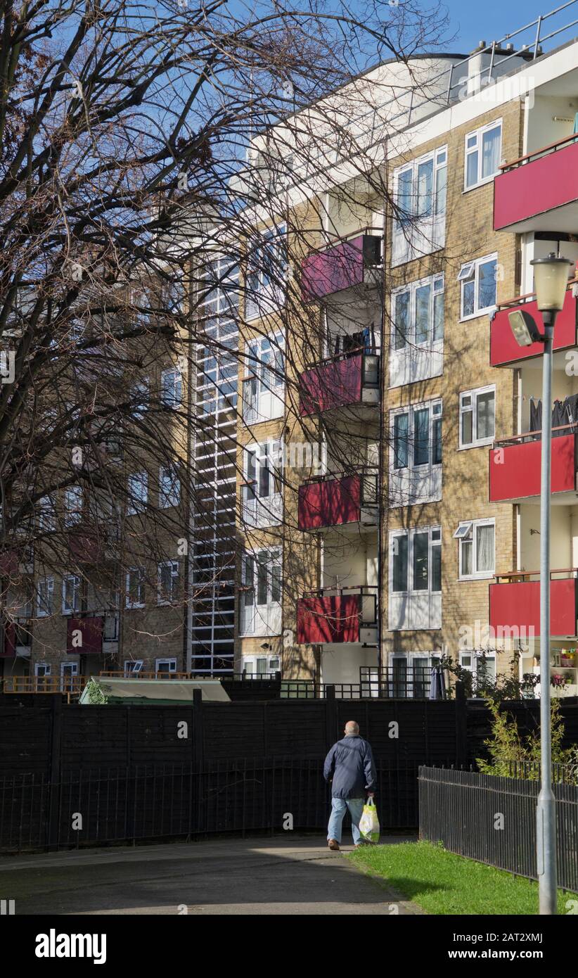 Resident walking outside a social council housing estate in Hackney ...
