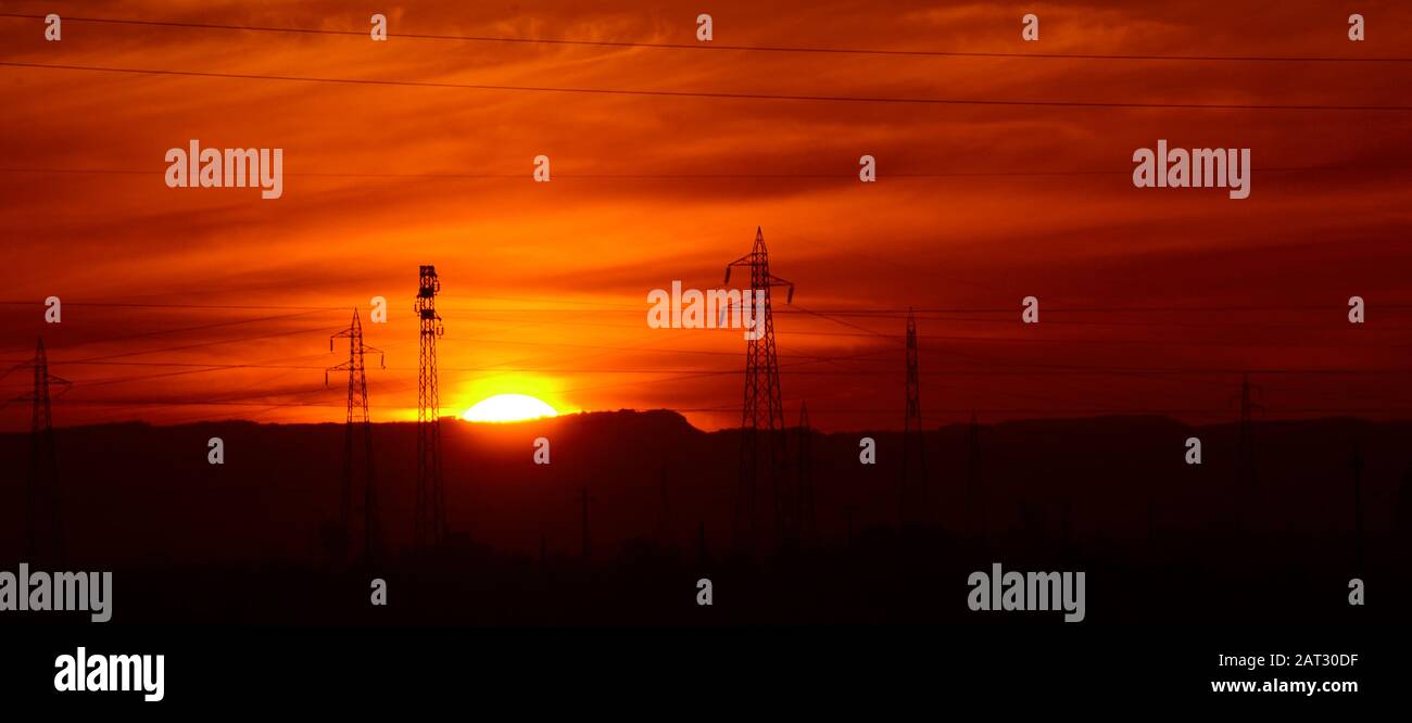 electricity transmission tower at sunset Stock Photo - Alamy