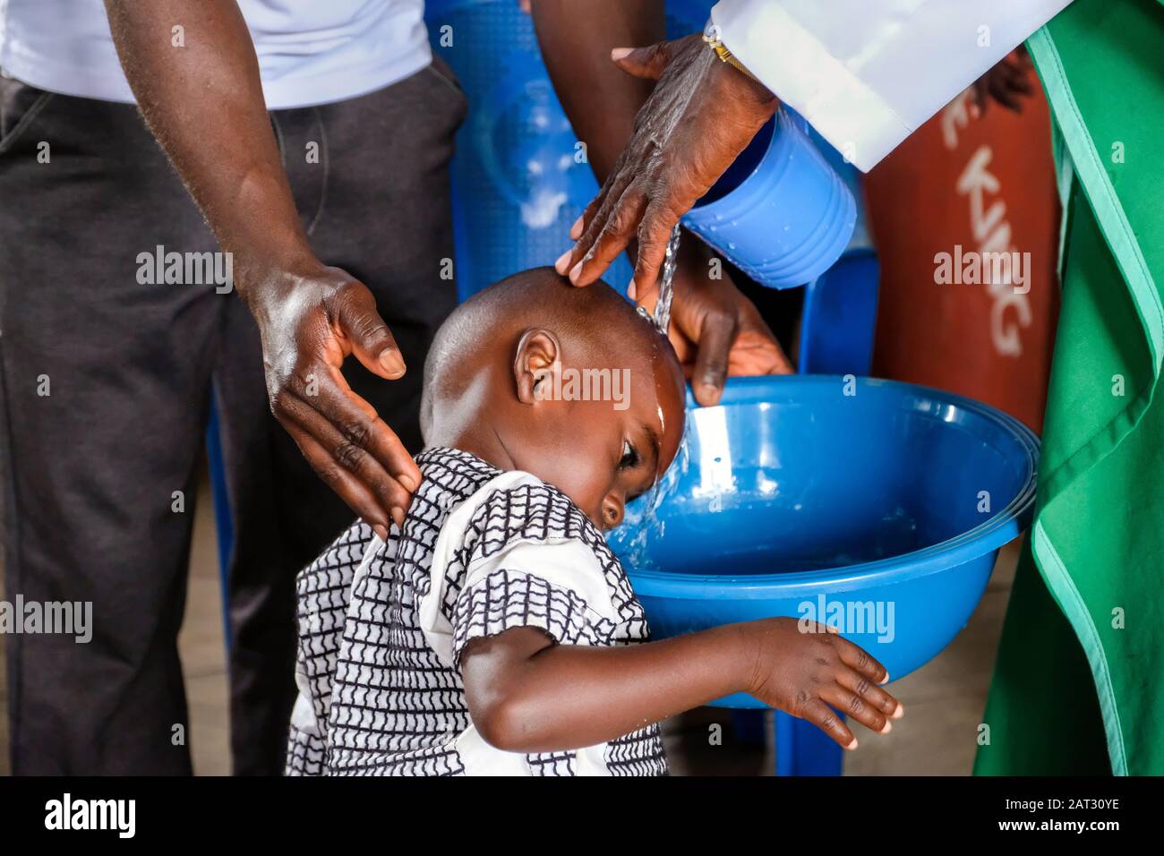 Baptism of a child in the catholic chapel in the stilt village of ...
