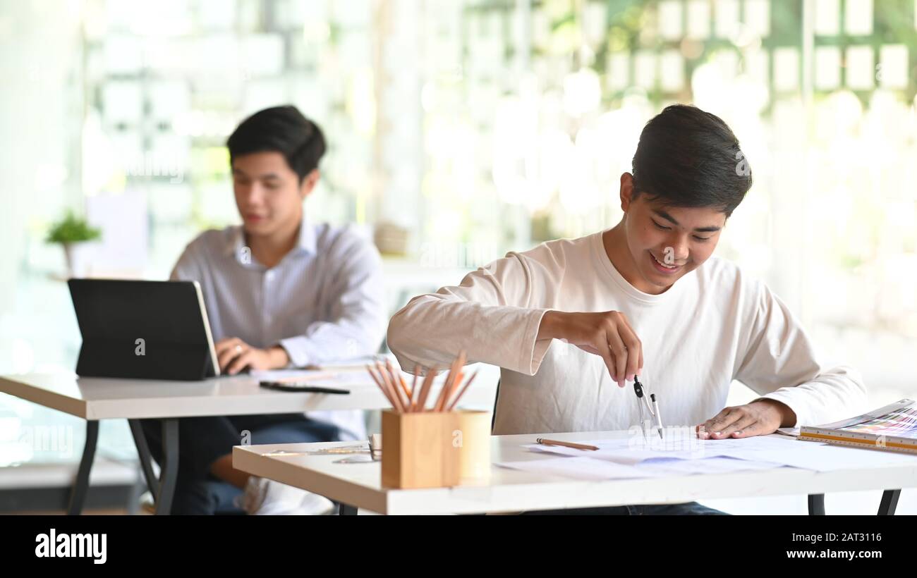 Photo of Architect team while they are drawing an Architecture plan and ...