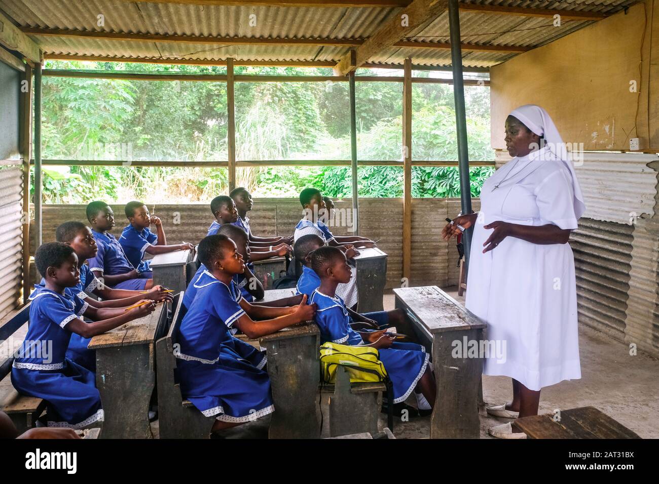 A teacher (Catholic nun) teaches students in a classroom at the St ...