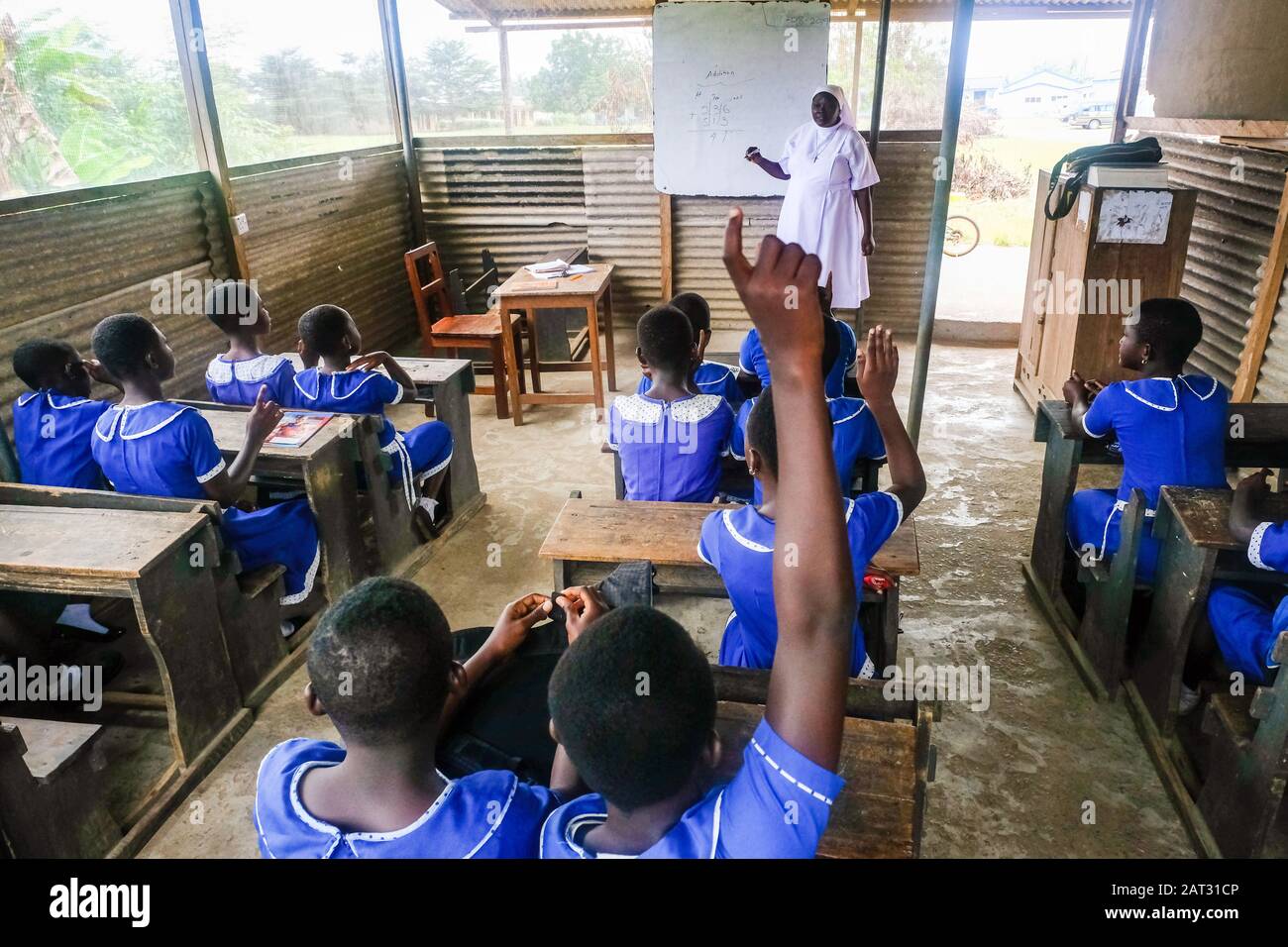 A teacher (Catholic nun) teaches students in a classroom at the St ...
